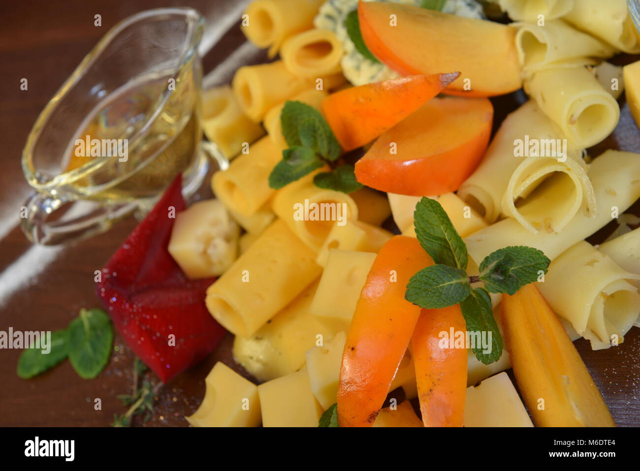 Assorted sliced cheese with mildew, blue, brie, swiss , cheddar ...