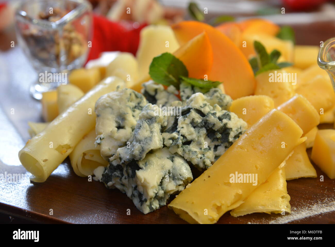 Assorted sliced cheese with mildew, blue, brie, swiss , cheddar ...