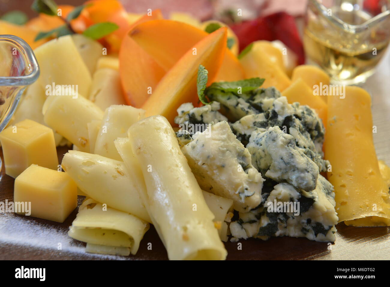 Assorted sliced cheese with mildew, blue, brie, swiss , cheddar ...