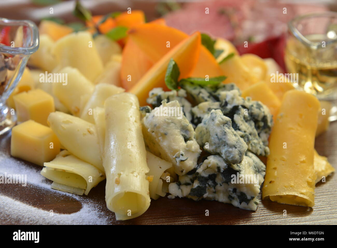 Assorted sliced cheese with mildew, blue, brie, swiss , cheddar ...