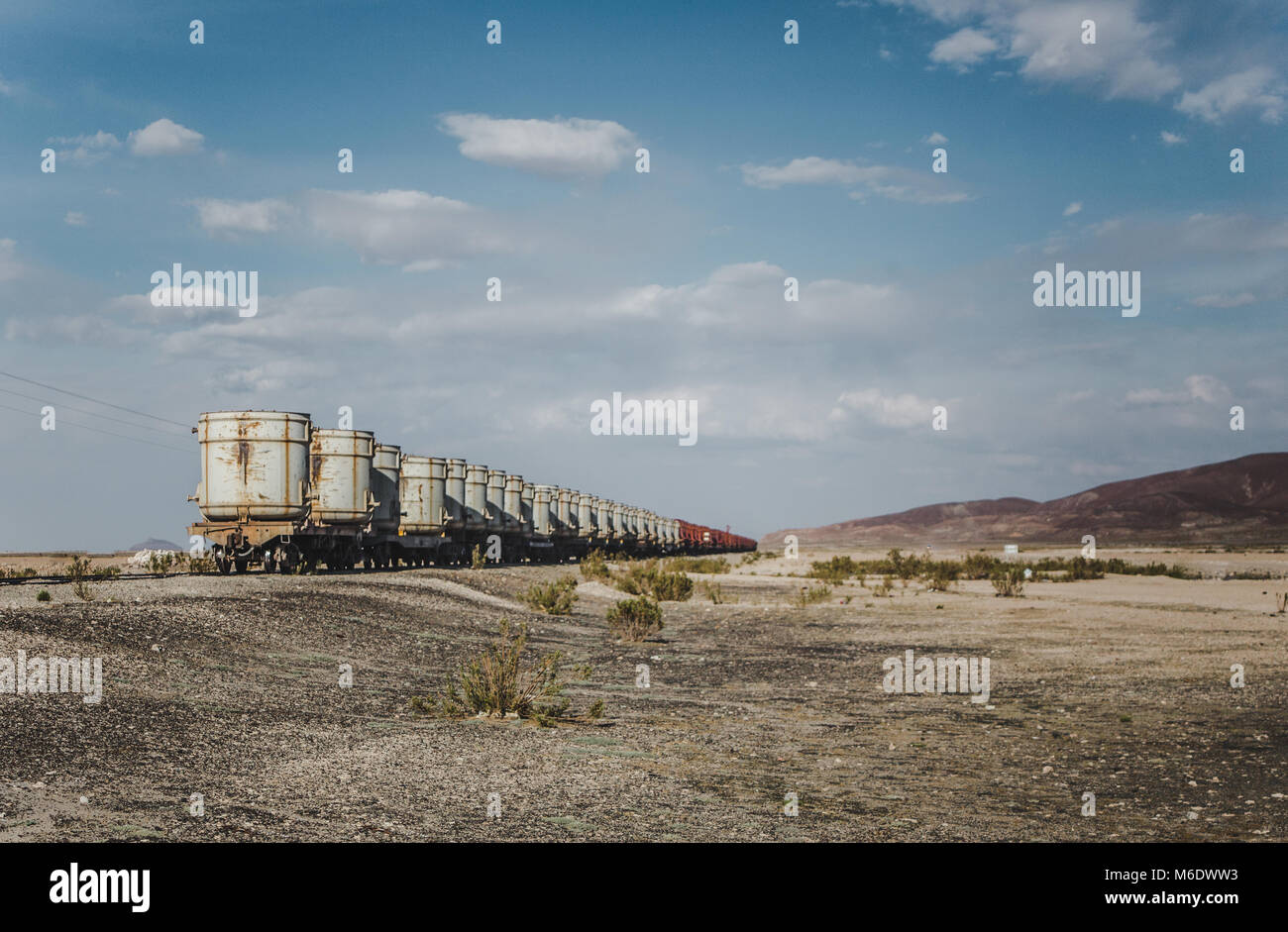 Freight cargo in large white shipping container cylinders being ...