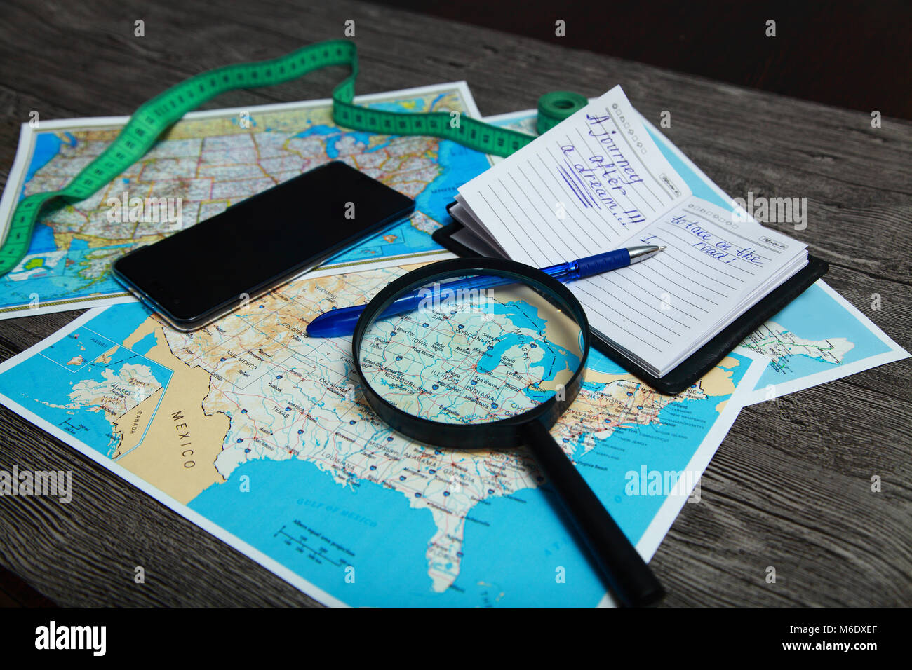 On the table is a map of the United States, phone, meter, pen ...