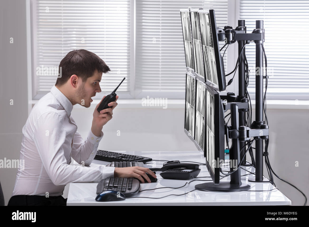 Security guard talking on walkie talkie hi-res stock photography and ...
