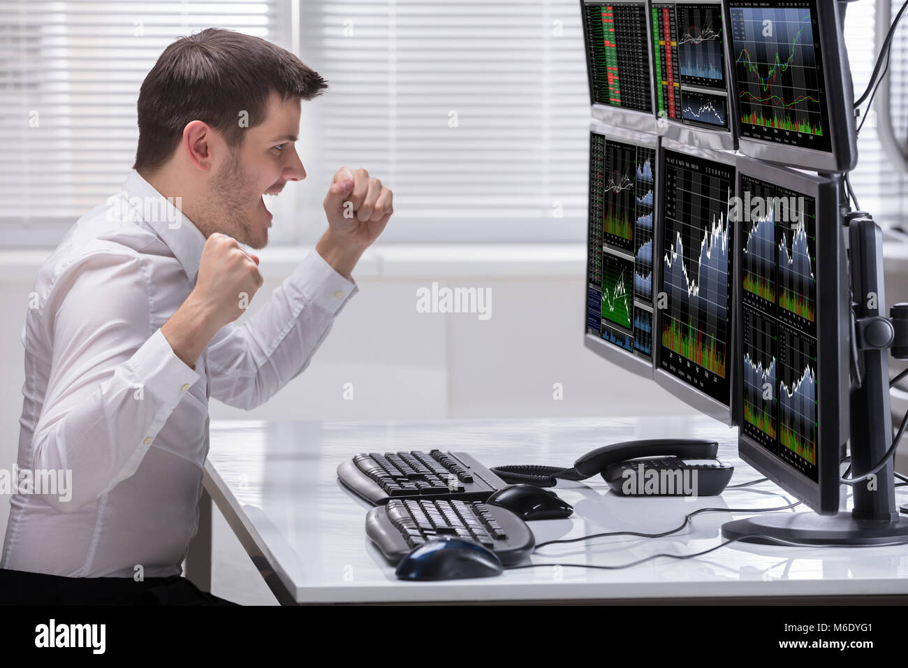 Side View Of A Happy Male Stock Market Broker Looking At Rising Stock Charts Stock Photo - Alamy