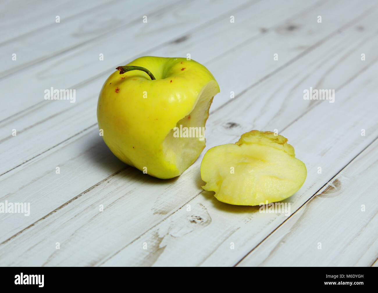 Apple with a missing part that lies nearby. Looks a bit like the Apple ...