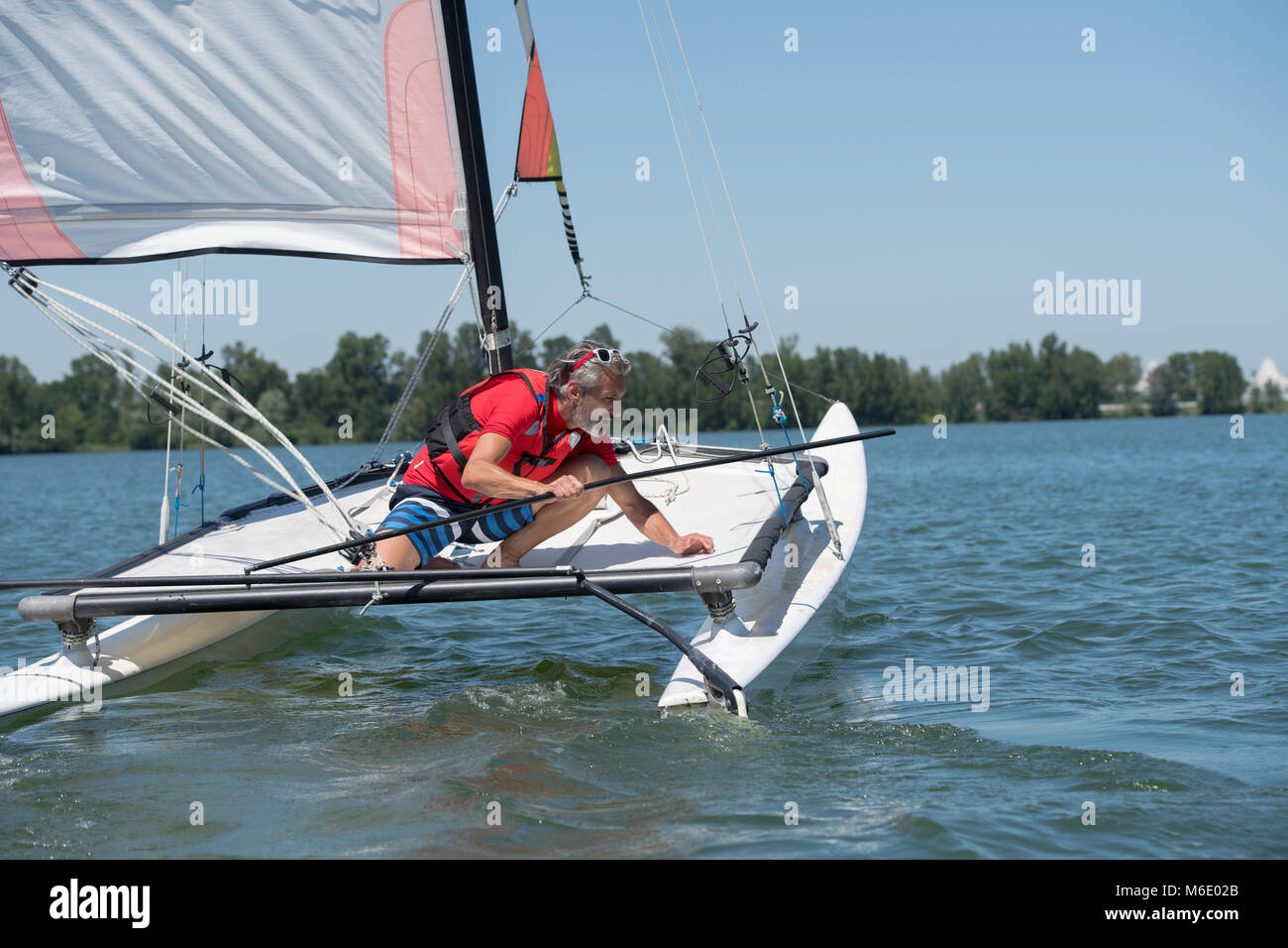 man sailing with sails out on a sunny day Stock Photo - Alamy