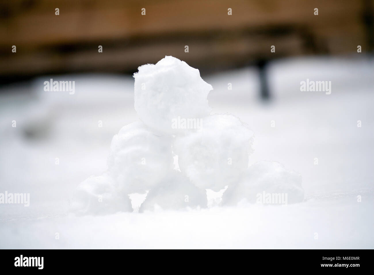 real snowballs with their hands clasped from the fresh snow in winter ...