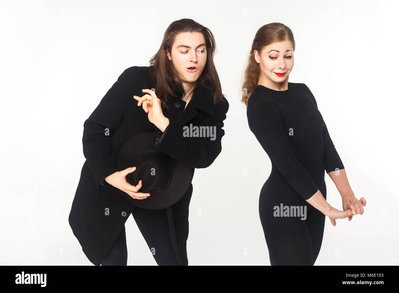 Playful man flirt with confused cute woman. Love concept. Studio shot ...