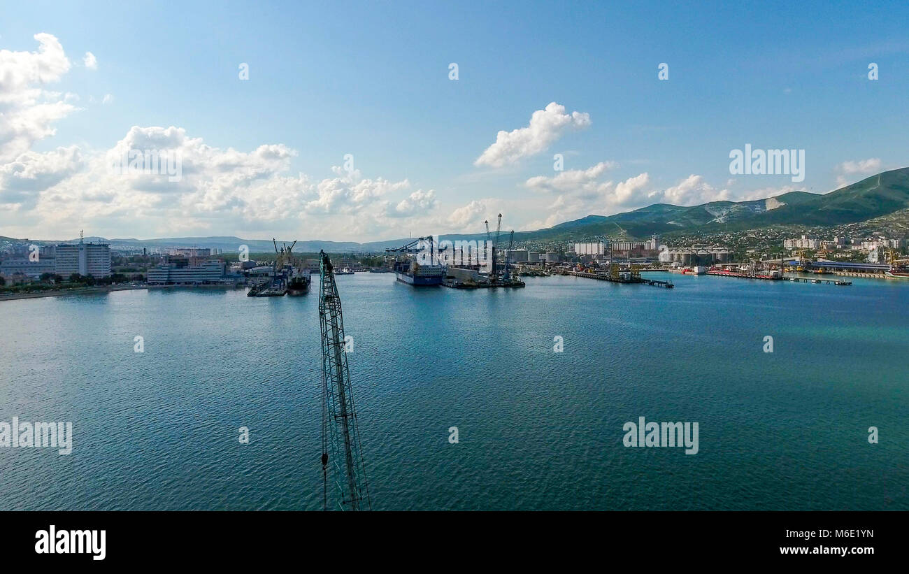 Industrial seaport, top view. Port cranes and cargo ships and barges ...