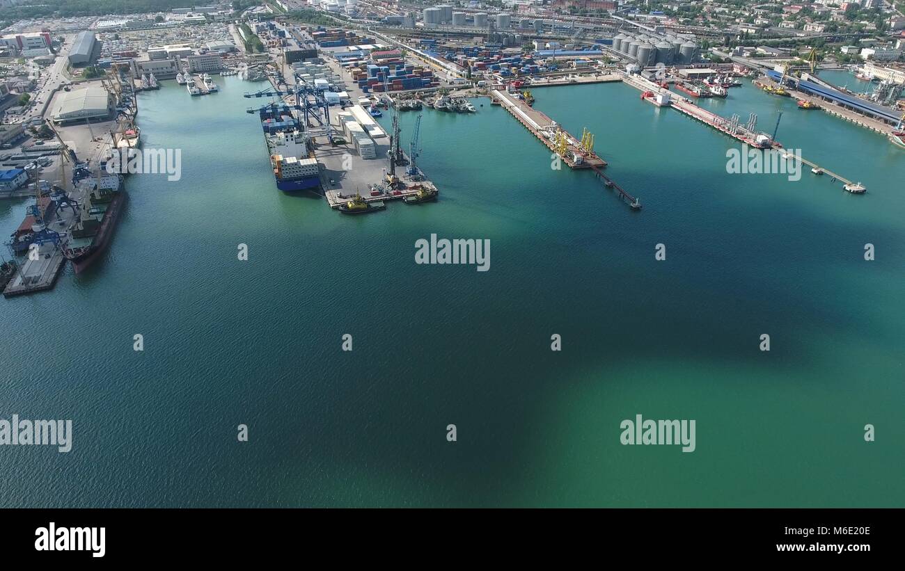 Industrial seaport, top view. Port cranes and cargo ships and barges ...