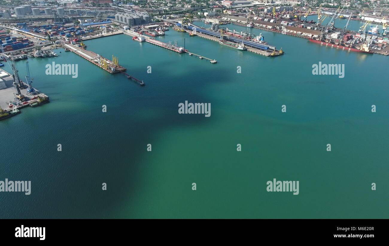 Industrial seaport, top view. Port cranes and cargo ships and barges ...