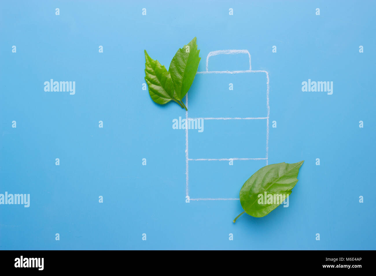 Eco green energy battery on blue background Stock Photo - Alamy