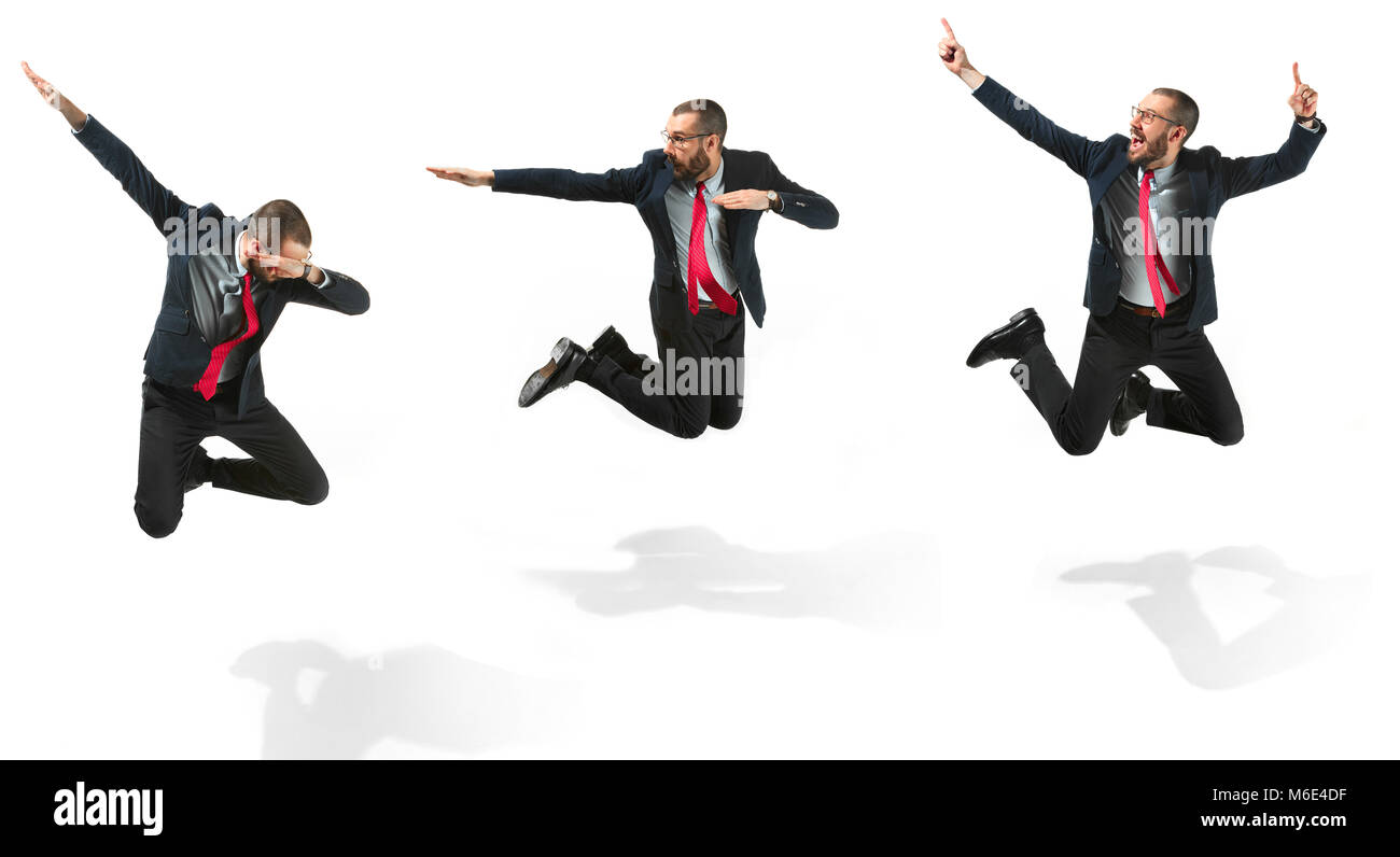 Funny cheerful businessman jumping in air over white studio background ...