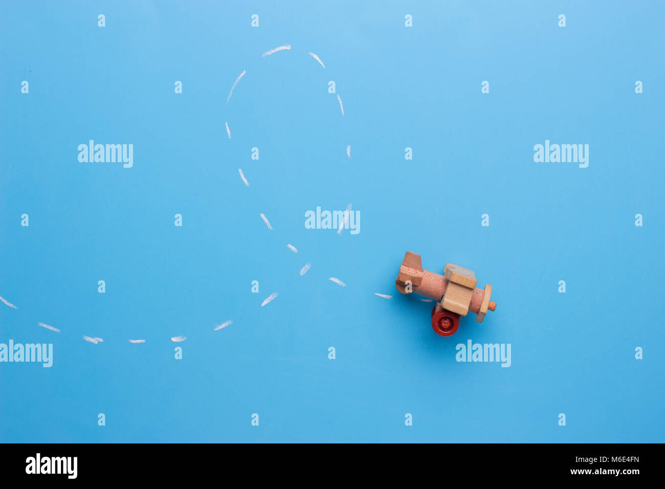 wooden plane performs a loop across blue background Stock Photo - Alamy
