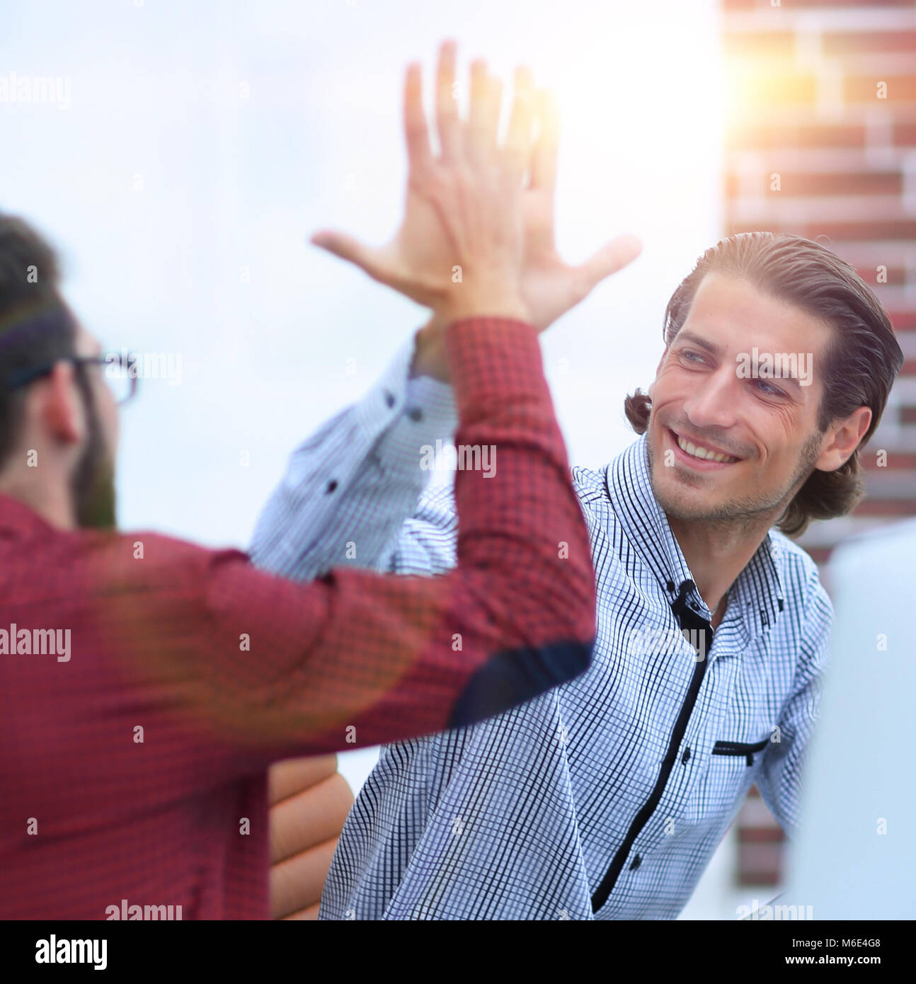 Businessman giving high five to his partner Stock Photo - Alamy