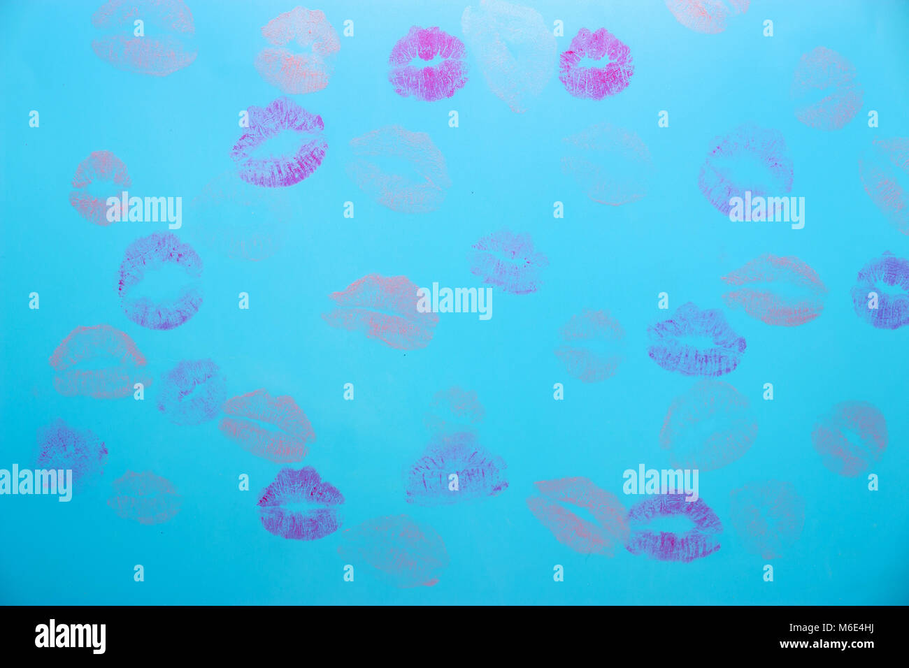 background from red lips imprint on blue background Stock Photo - Alamy