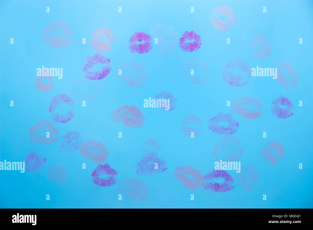 background from red lips imprint on blue background Stock Photo - Alamy