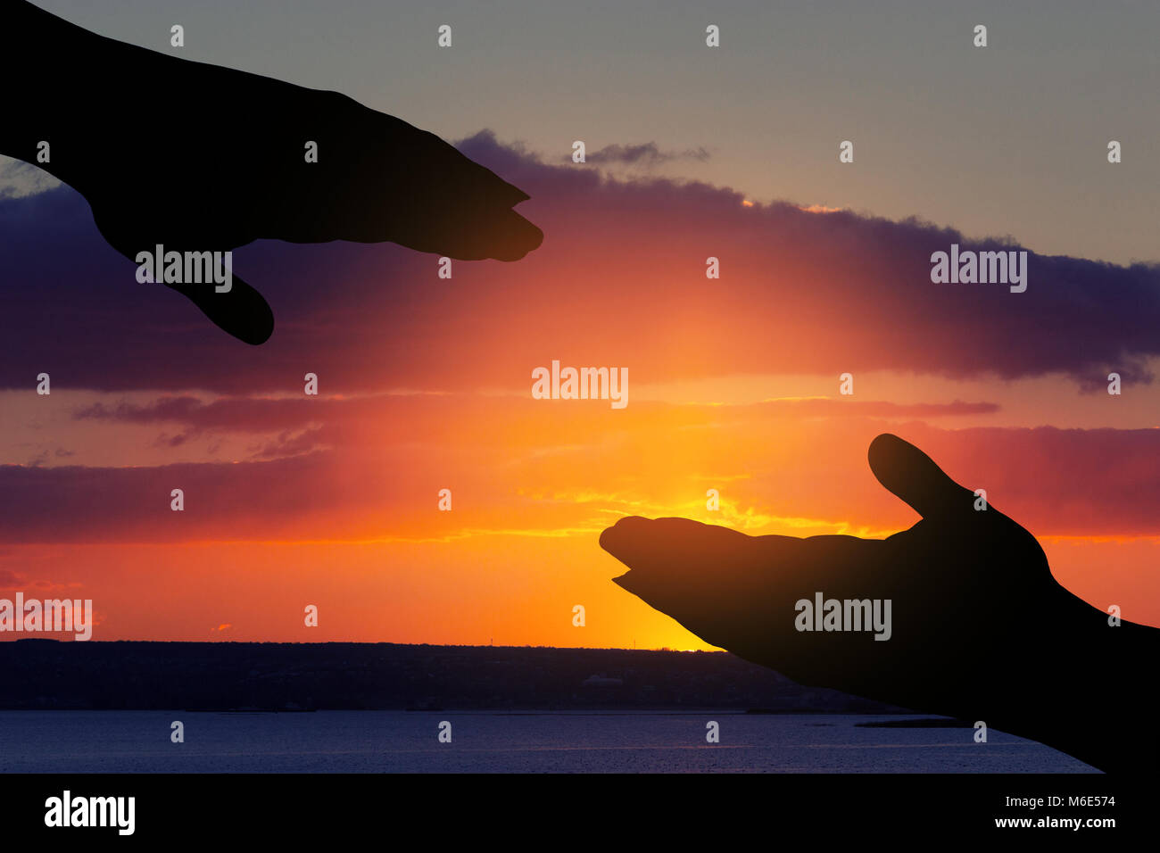 silhouette of helping hand on sky background Stock Photo - Alamy
