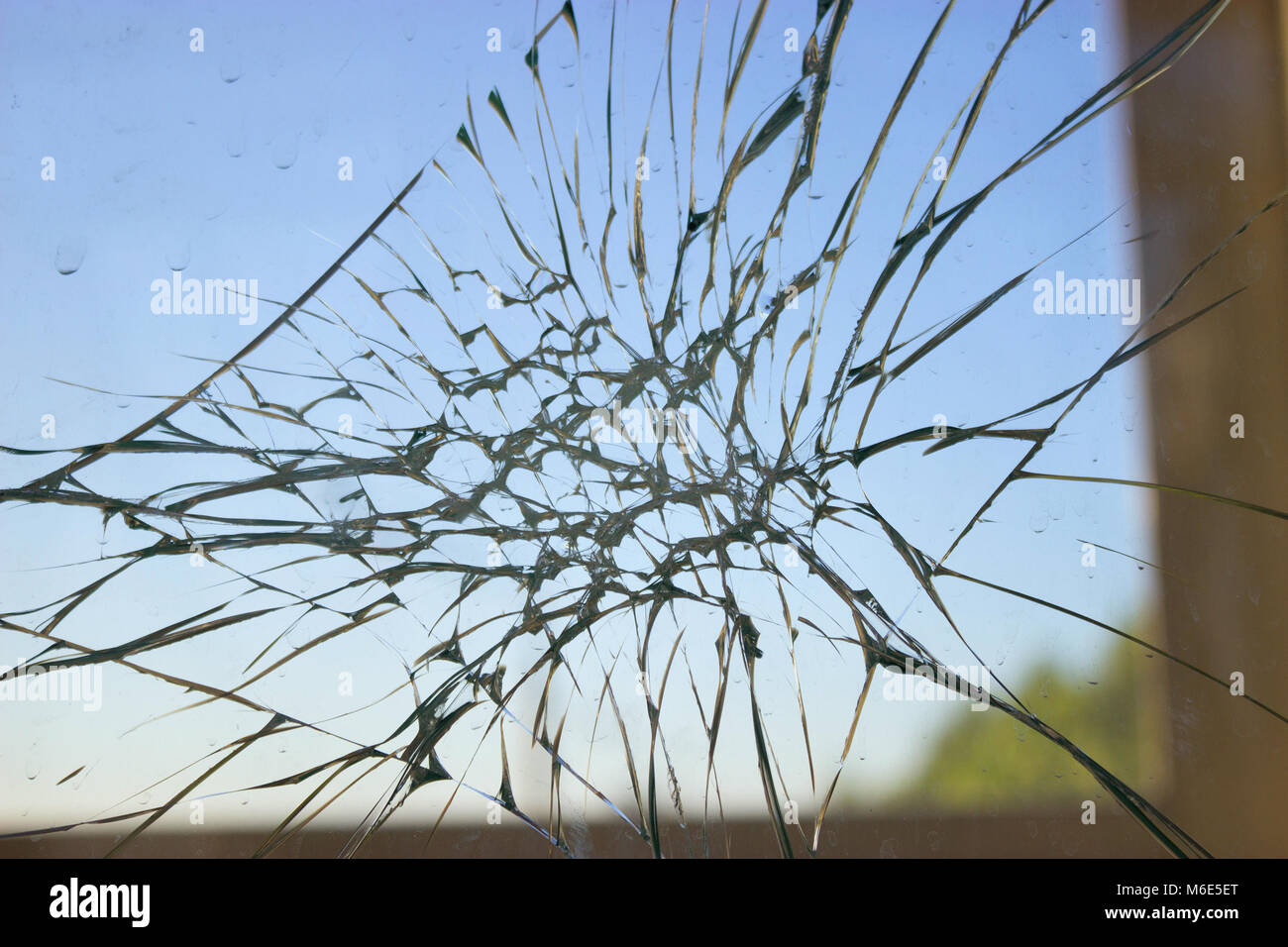 broken glass window reflecting blue sky. close up Stock Photo - Alamy