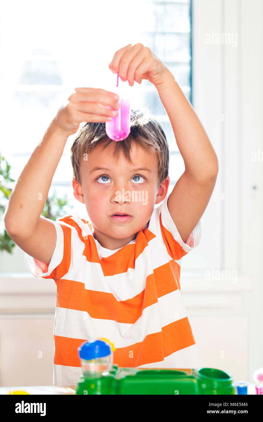 young boy experiments with different colors at home Stock Photo - Alamy