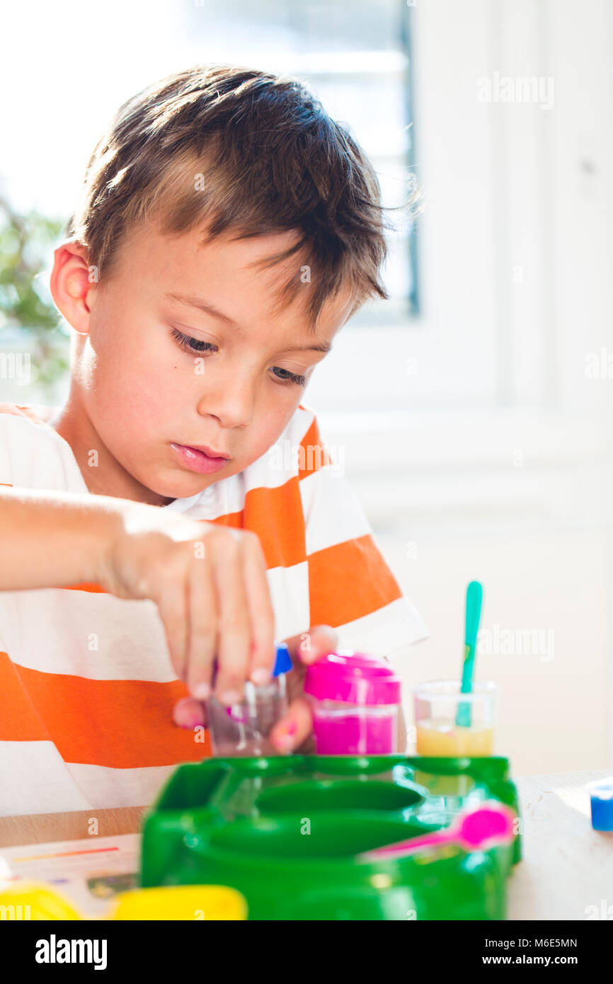 young boy experiments with different colors at home Stock Photo - Alamy