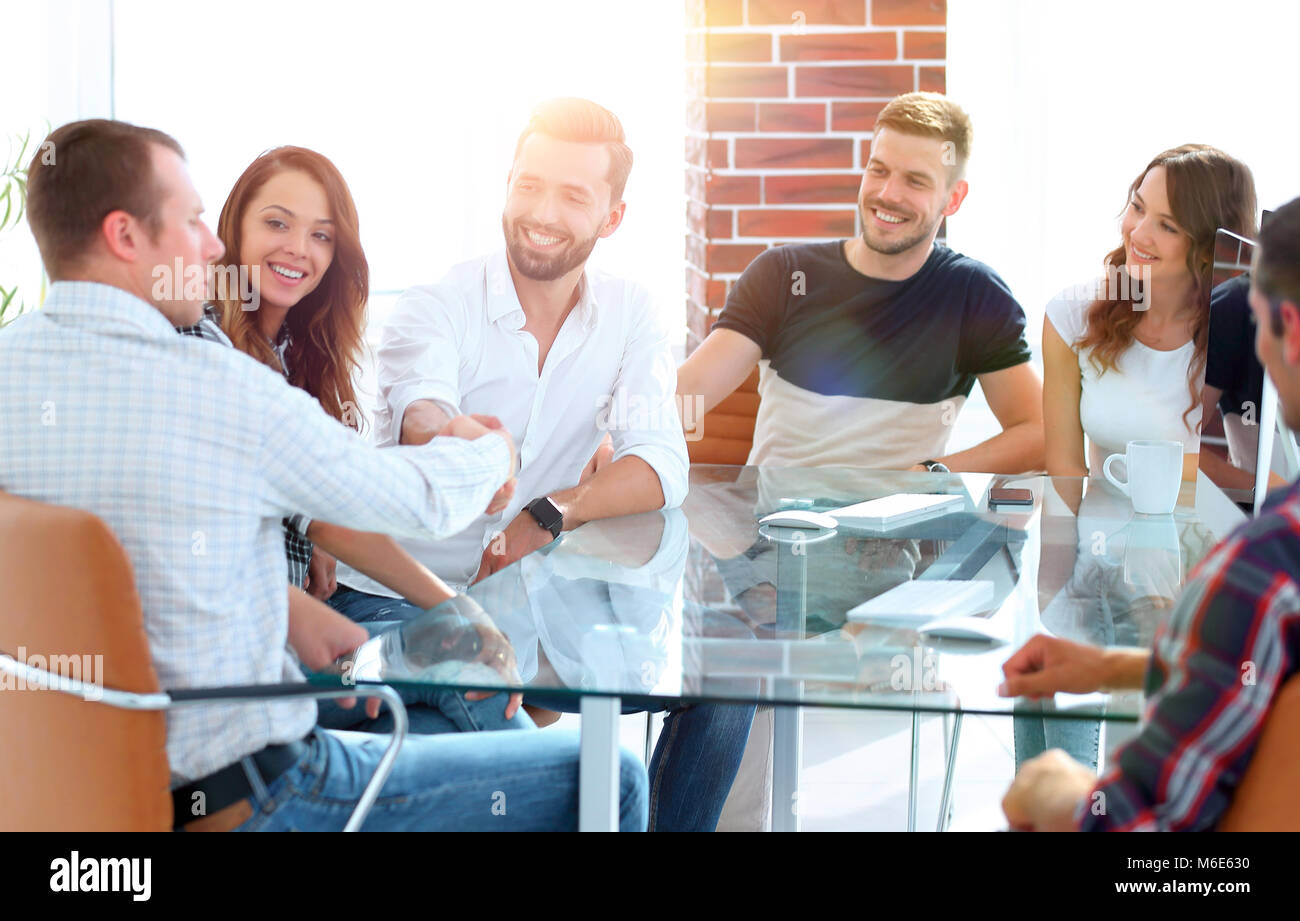 handshake of business partners sitting at the table Stock Photo - Alamy