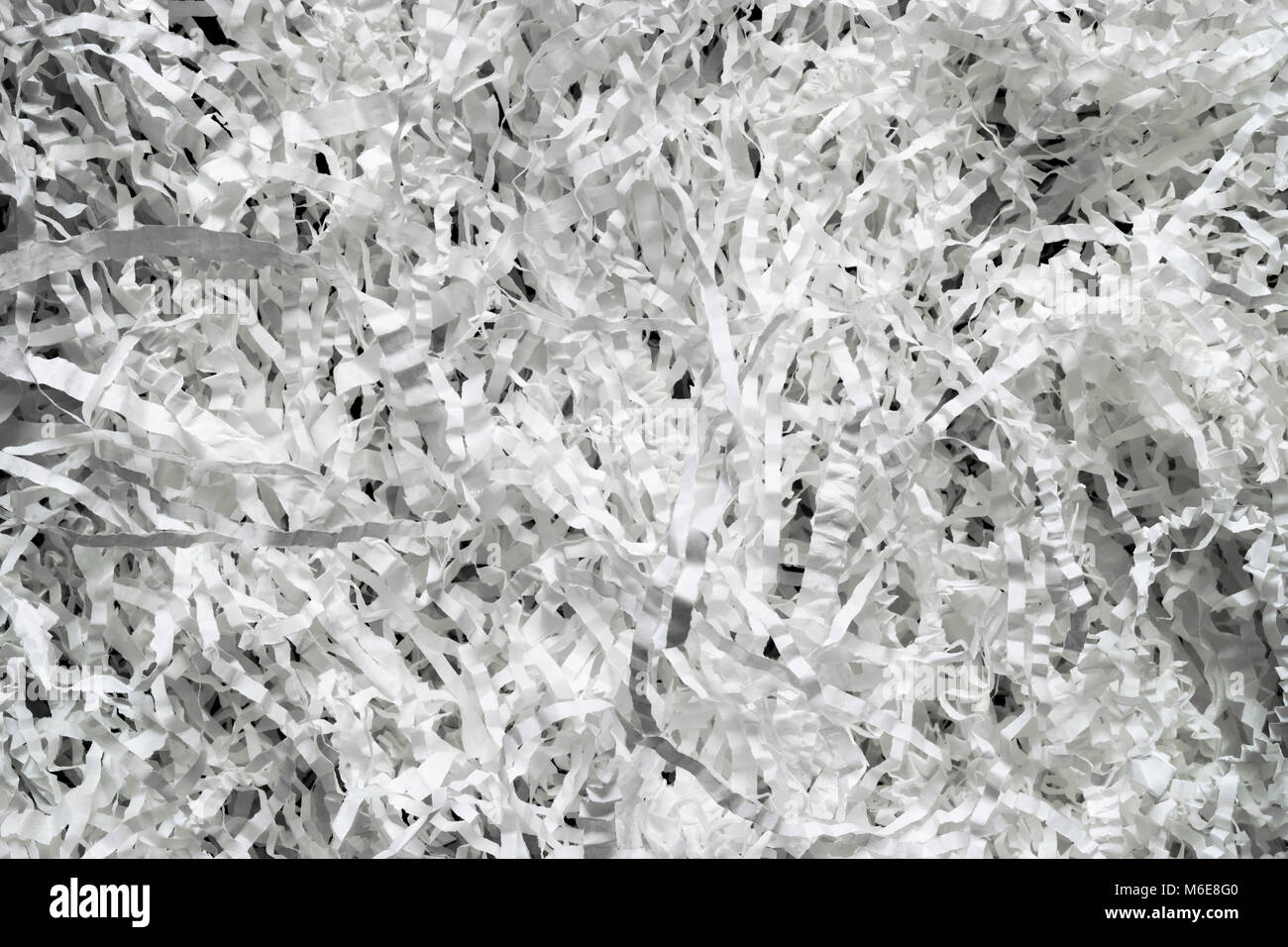 Shredded white curly paper strips background on black background Stock ...