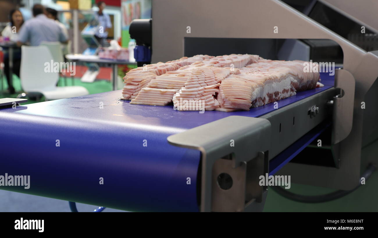 Ham on conveyor of food cutting machine Stock Photo - Alamy