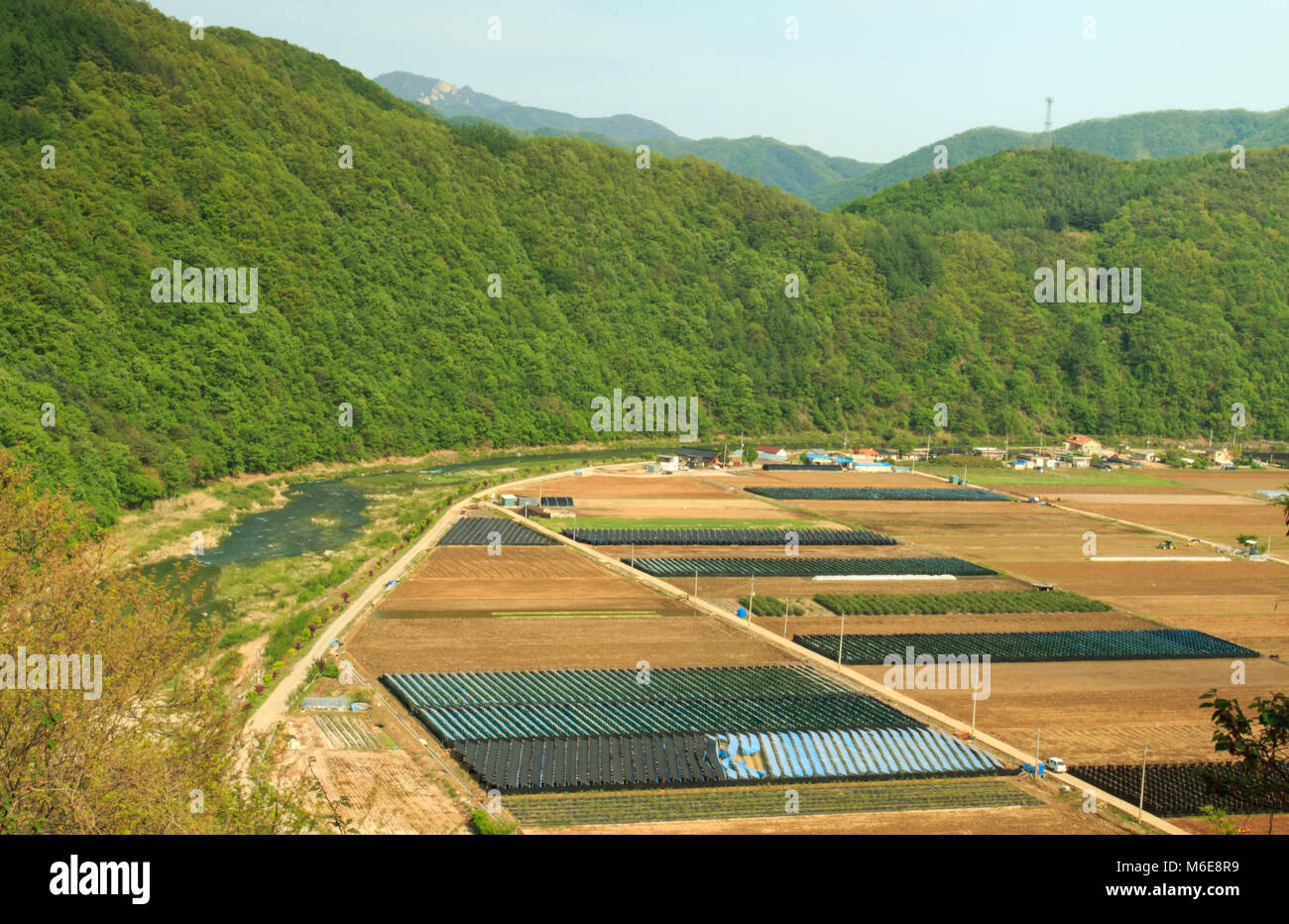 farmland and stream surrounded by mountains Stock Photo - Alamy