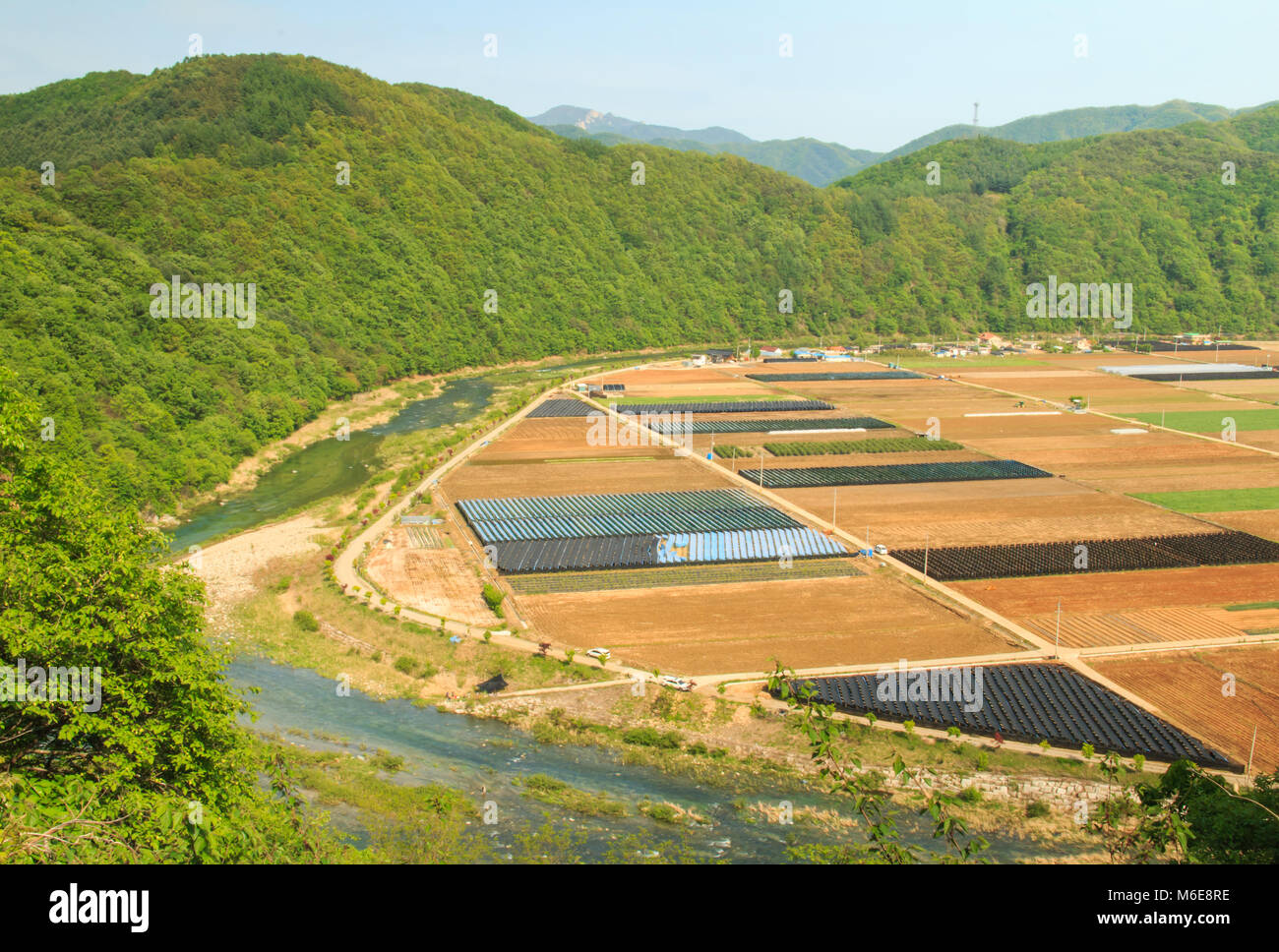 farmland and stream surrounded by mountains Stock Photo - Alamy