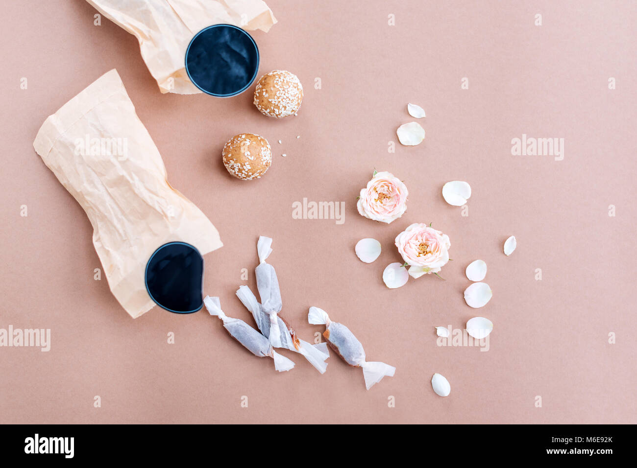 Handmade sweets in craft paper envelopes with flowers on pink ...