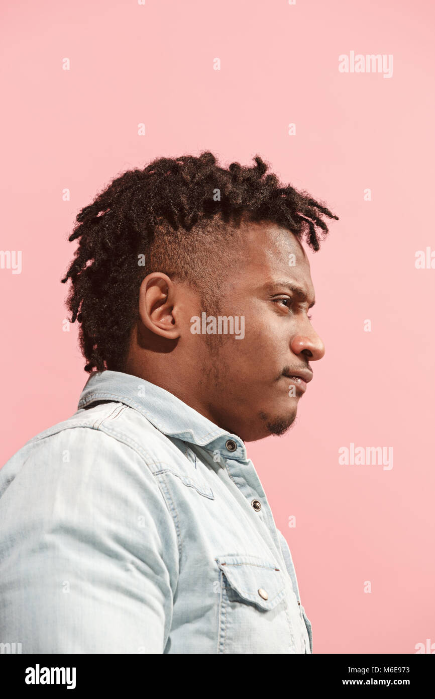 The suspicious business Afro-American man standing and suspiciously ...