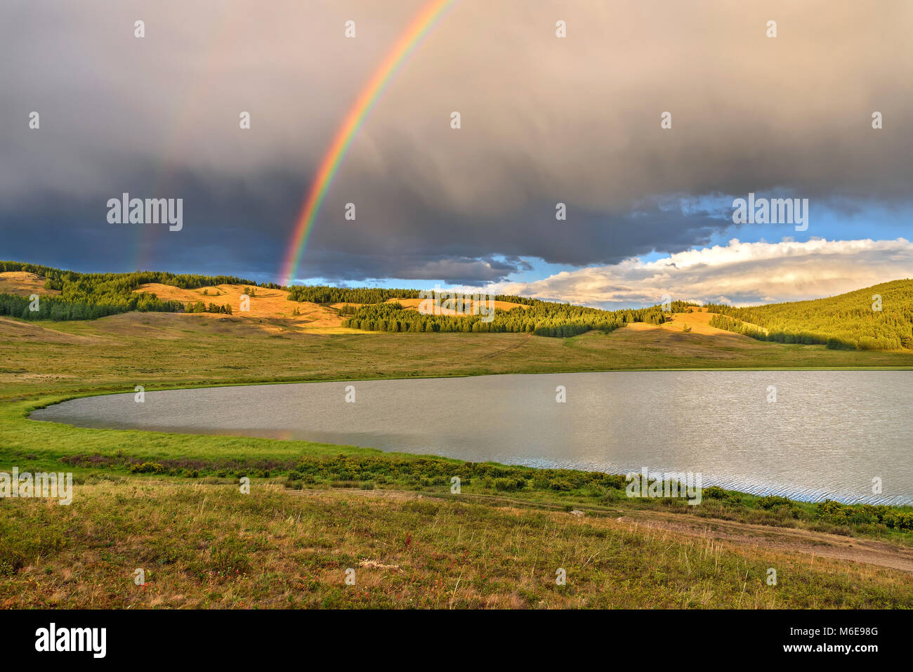 Rainbow in blue sky with white clouds hi-res stock photography and ...