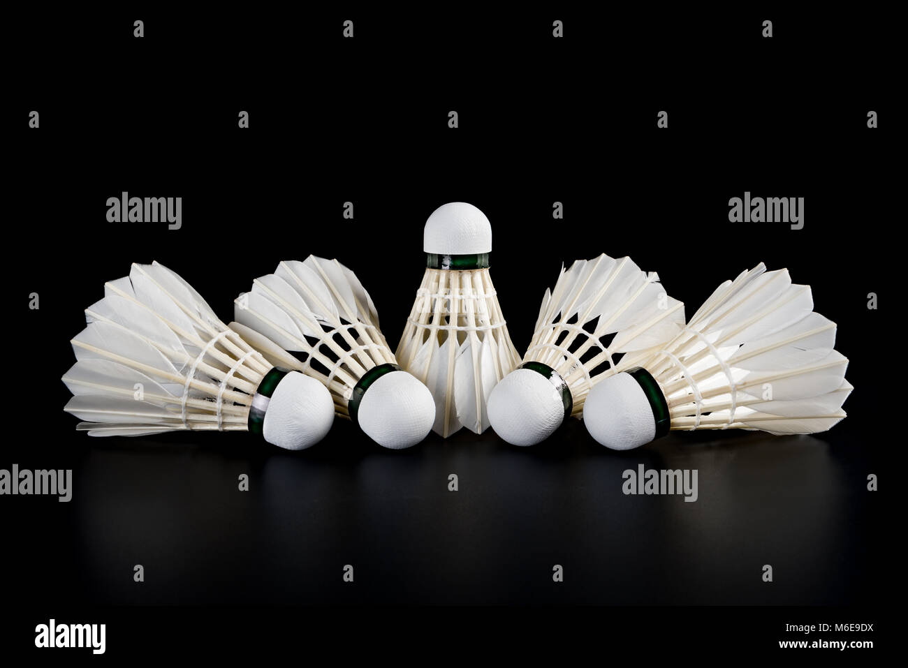 five brand new shuttlecocks on a black background Stock Photo - Alamy
