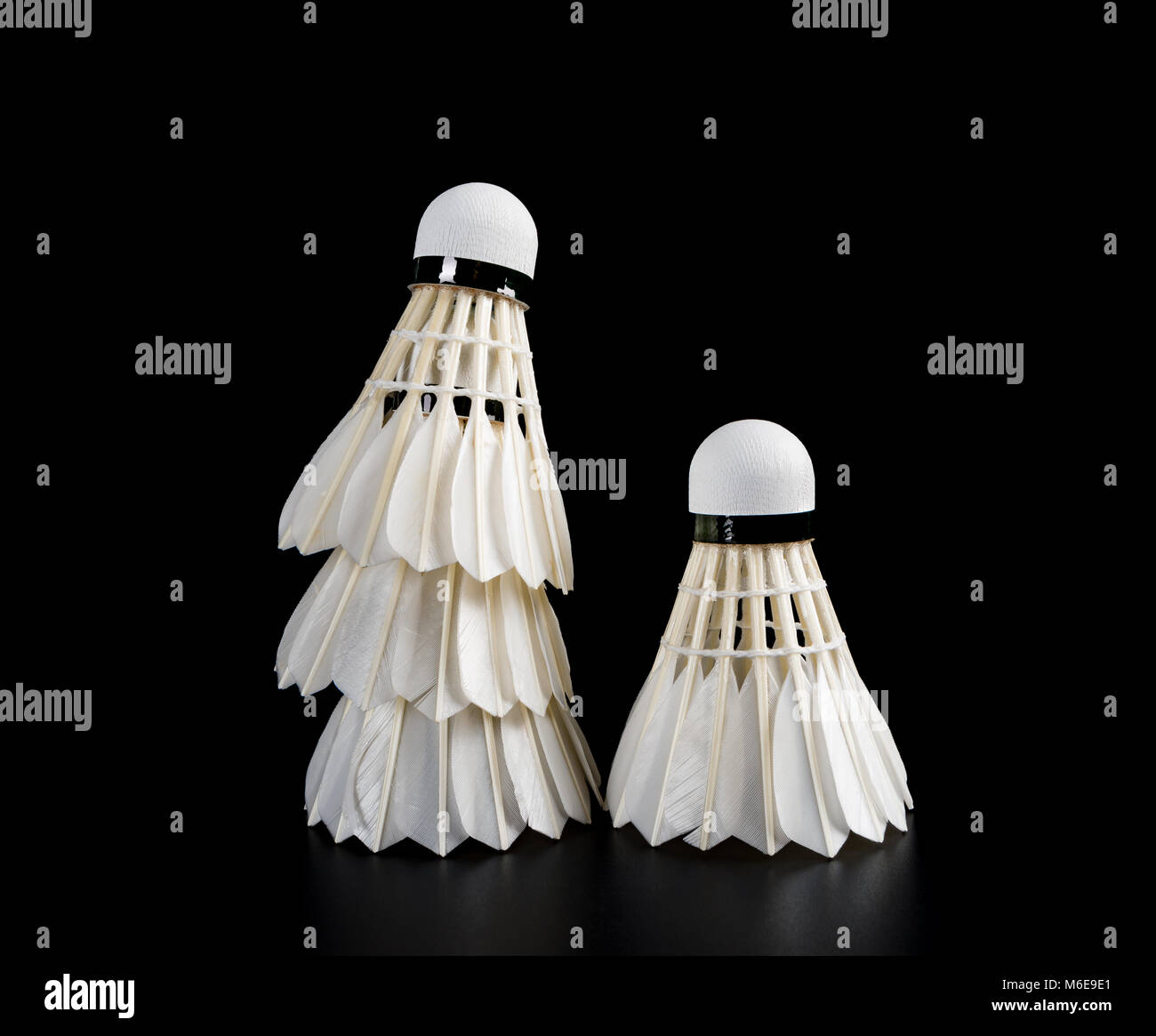 four brand new shuttlecocks on a black background Stock Photo - Alamy