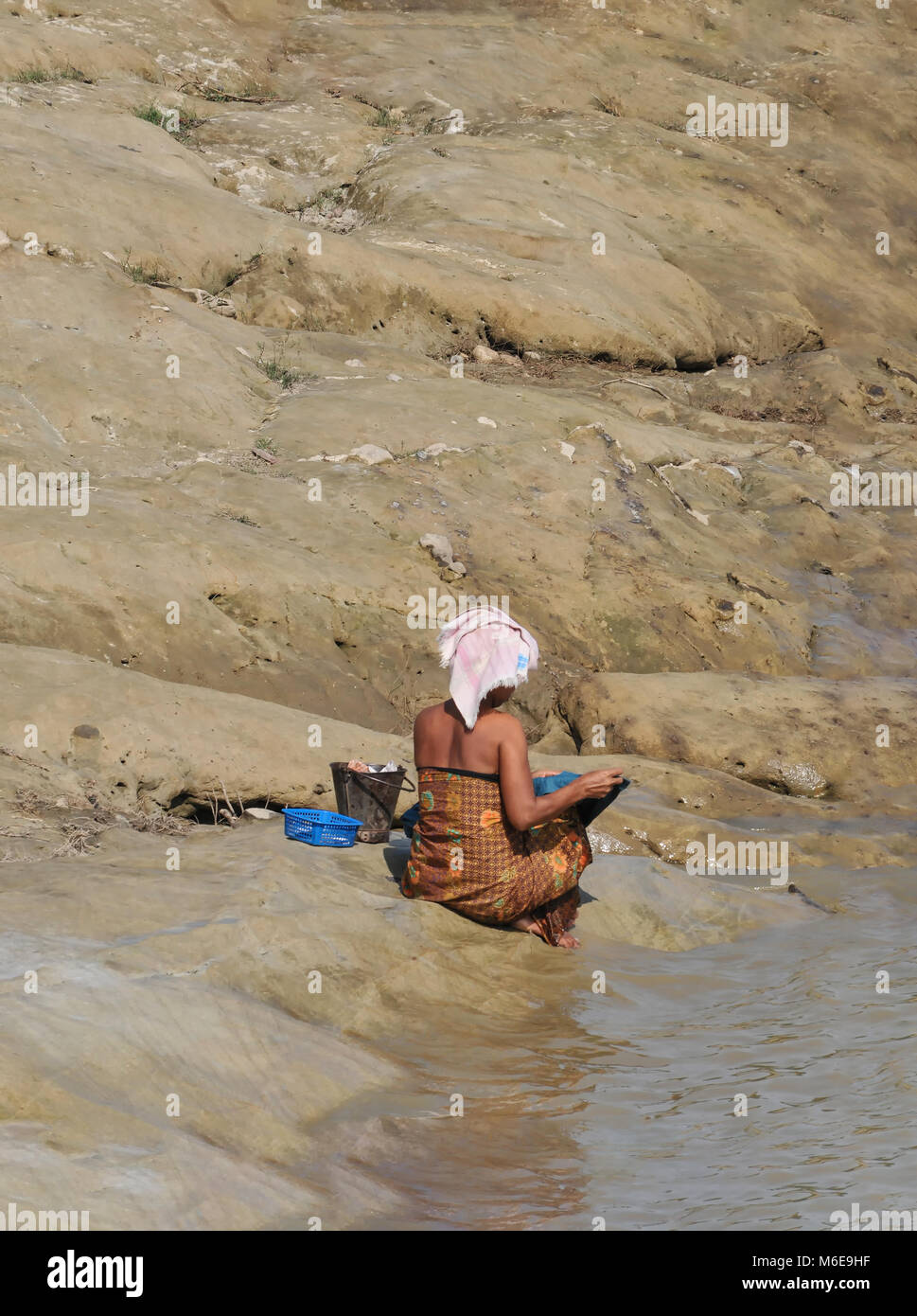 A woman bathing near the banks of the Irrawaddy River in Myanmar Burma ...