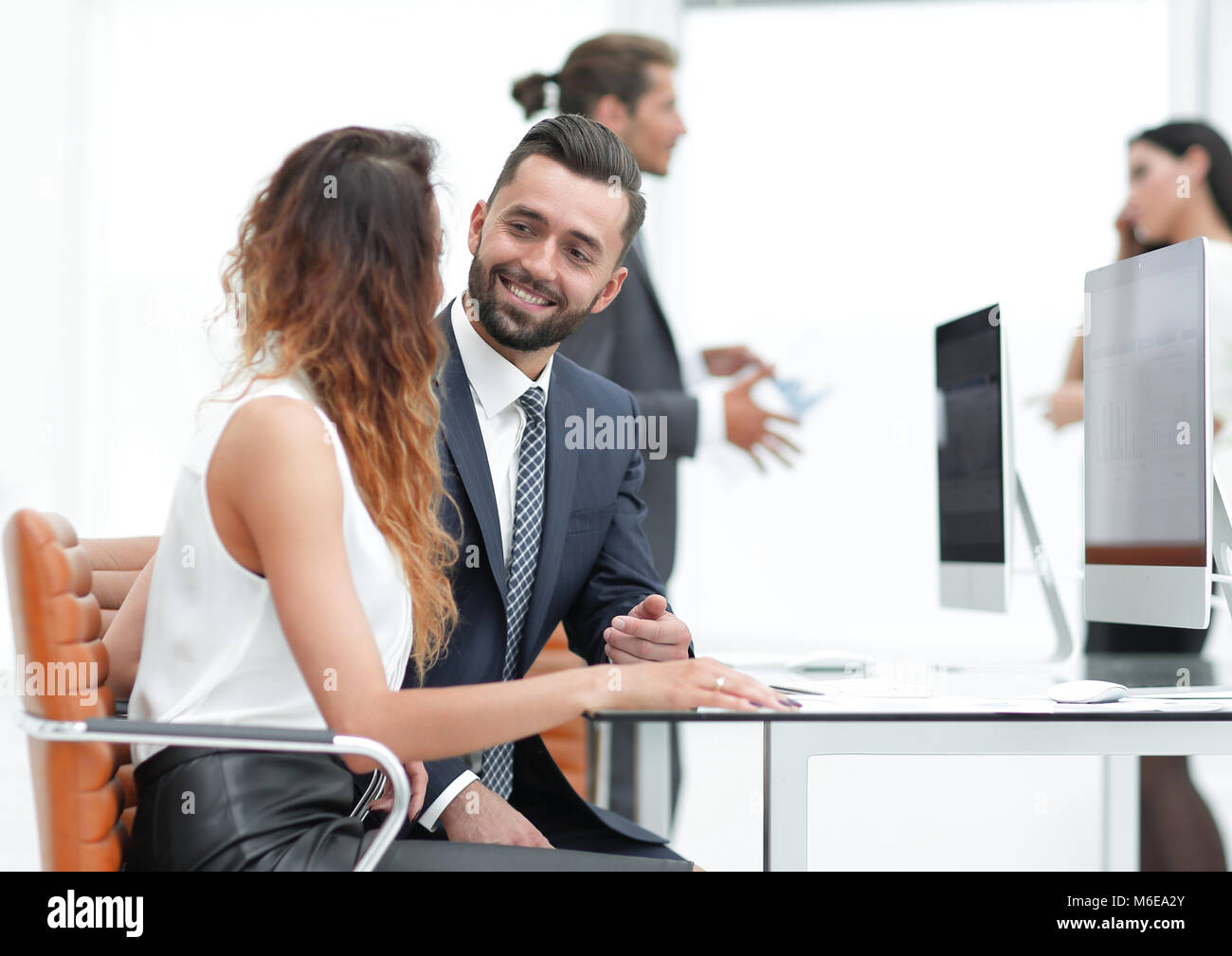 colleagues talking, sitting at your Desk Stock Photo - Alamy