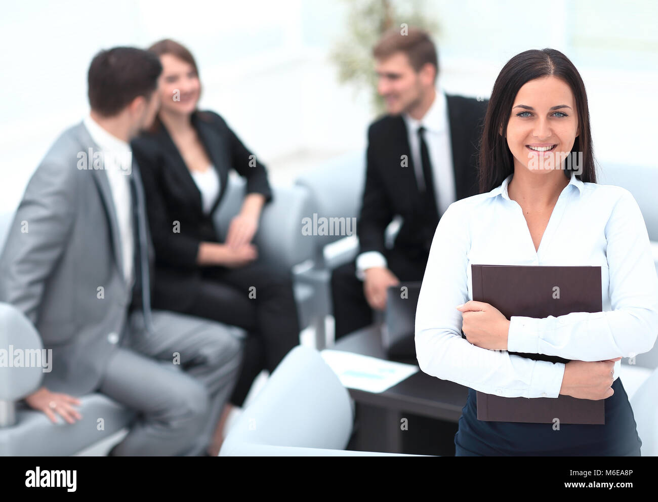 smiling female assistant with documents Stock Photo - Alamy