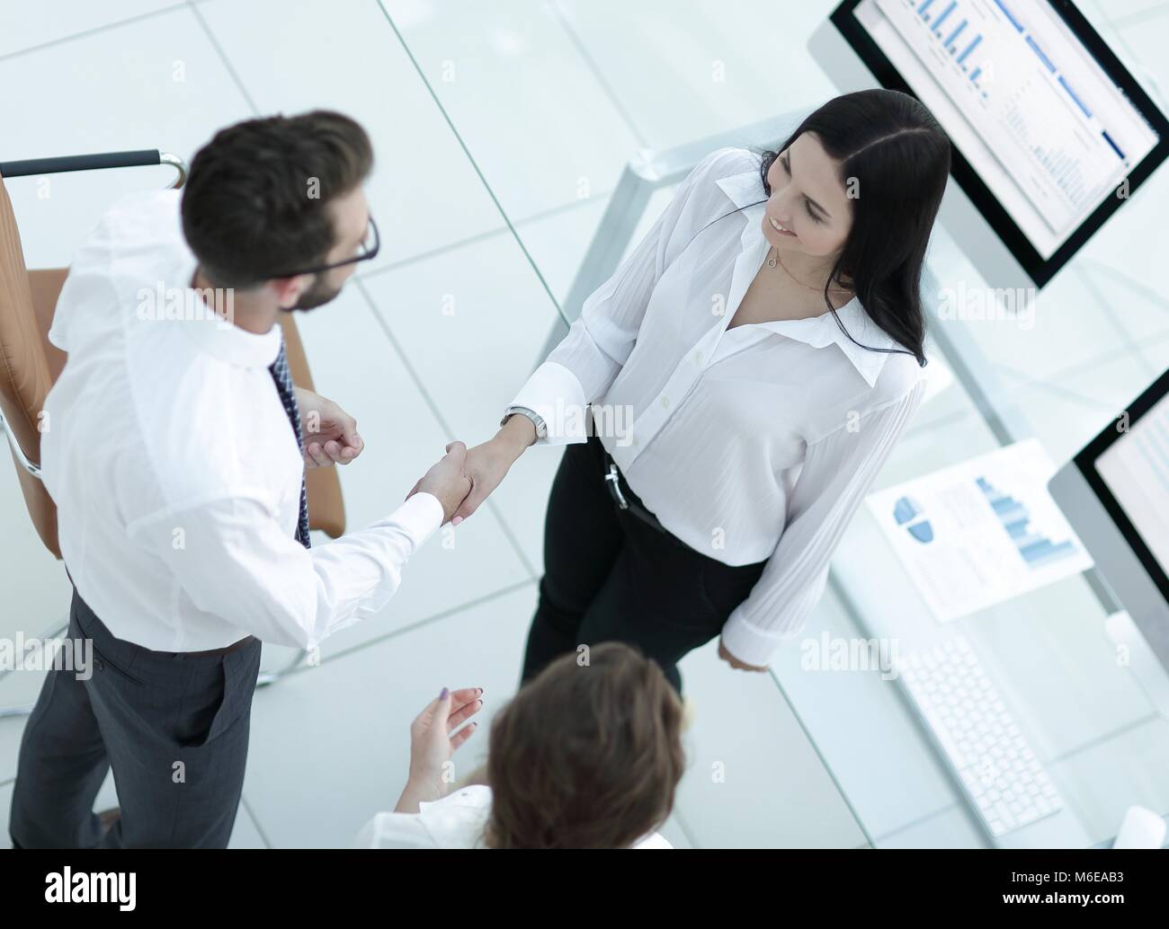 handshake manager and employee near the workplace Stock Photo - Alamy