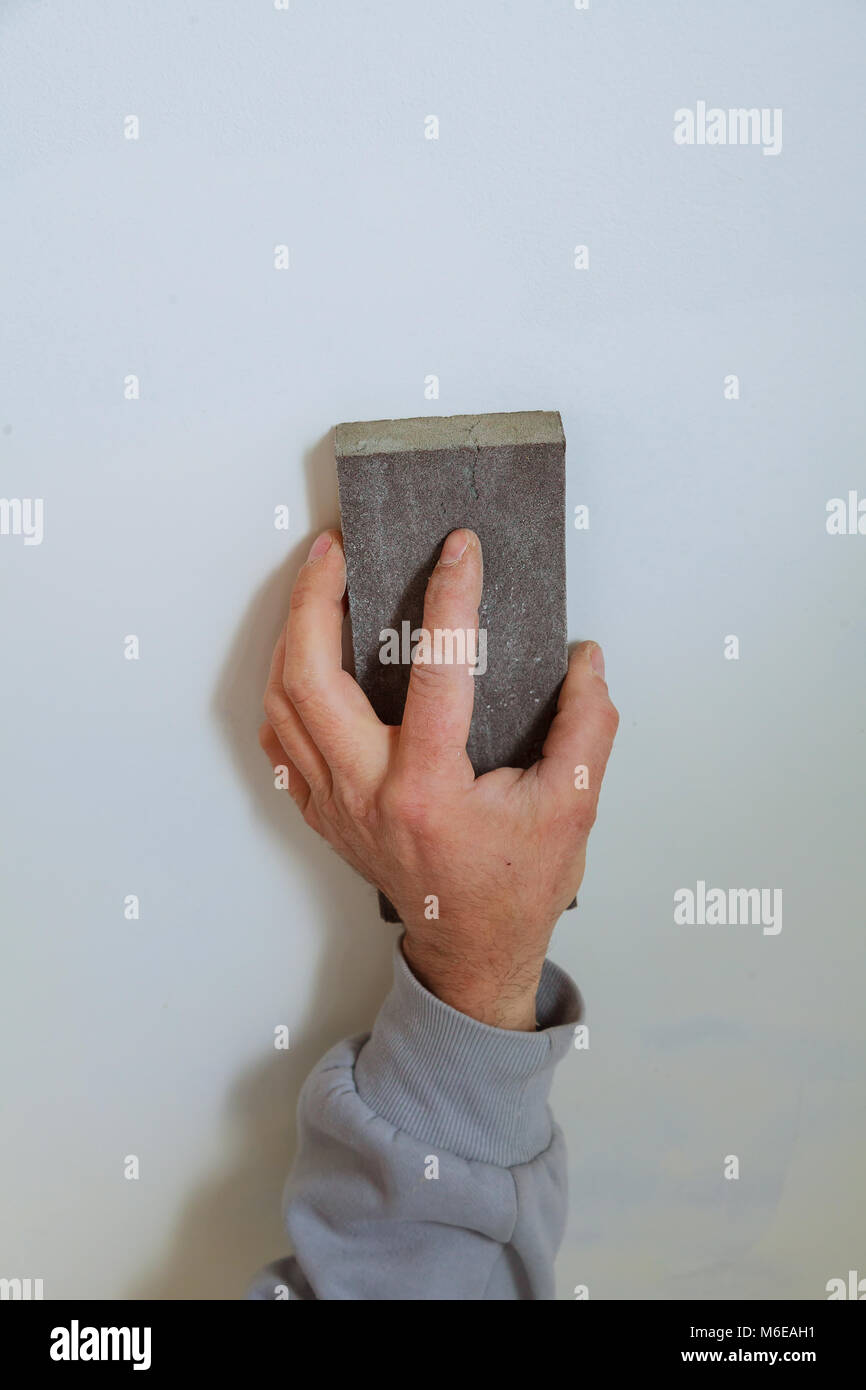 Master plasterer smooths the seams with plaster between plaster panels ...