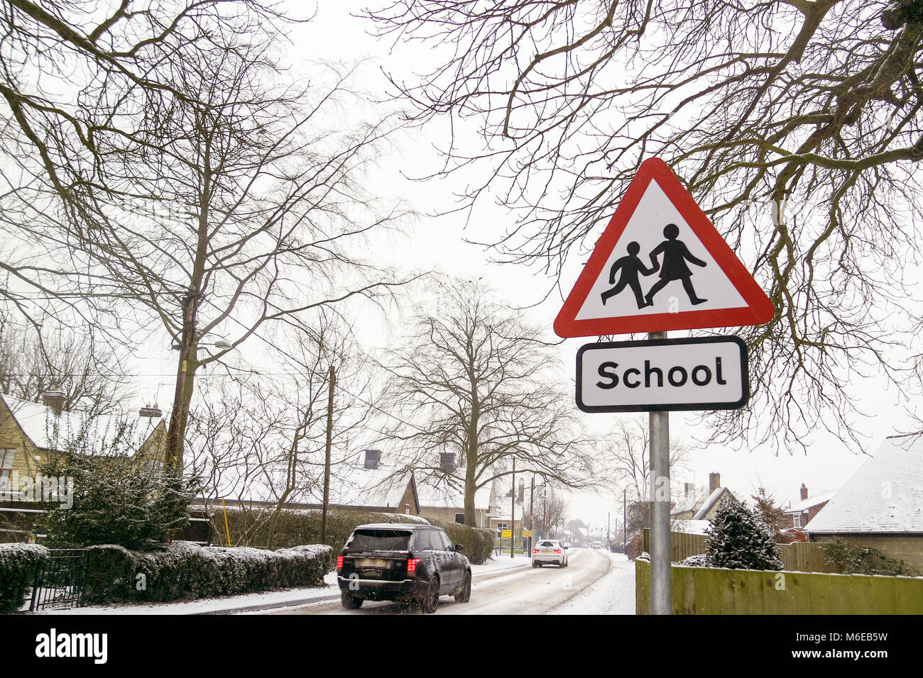 School closure: Village cut off by snow. Snow background. School sign ...