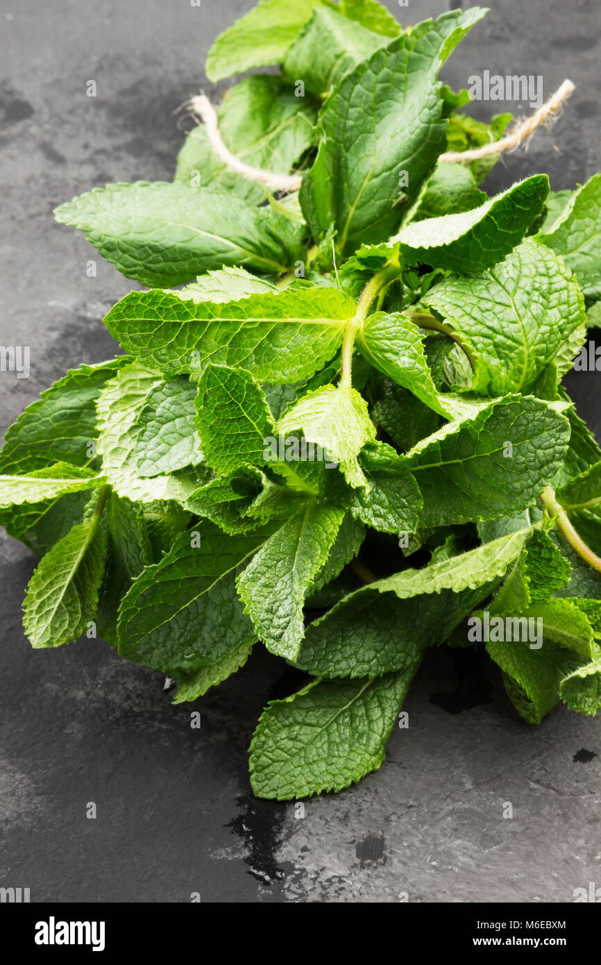 Bunch fresh mints on a dark background Stock Photo - Alamy