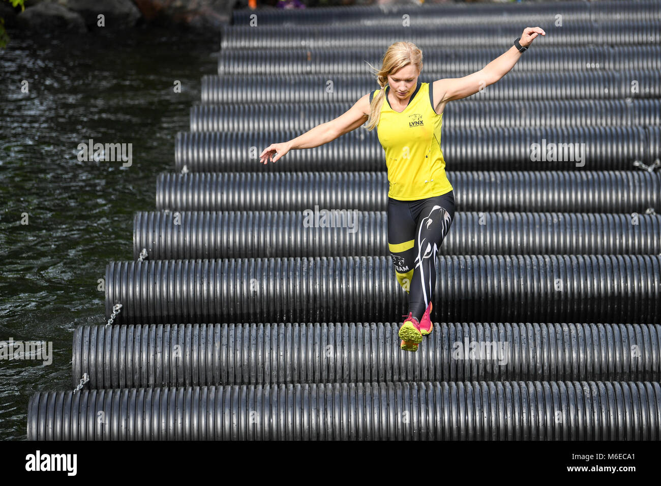 Participant crossing a water obstacle during Action run 2017 obstacle ...