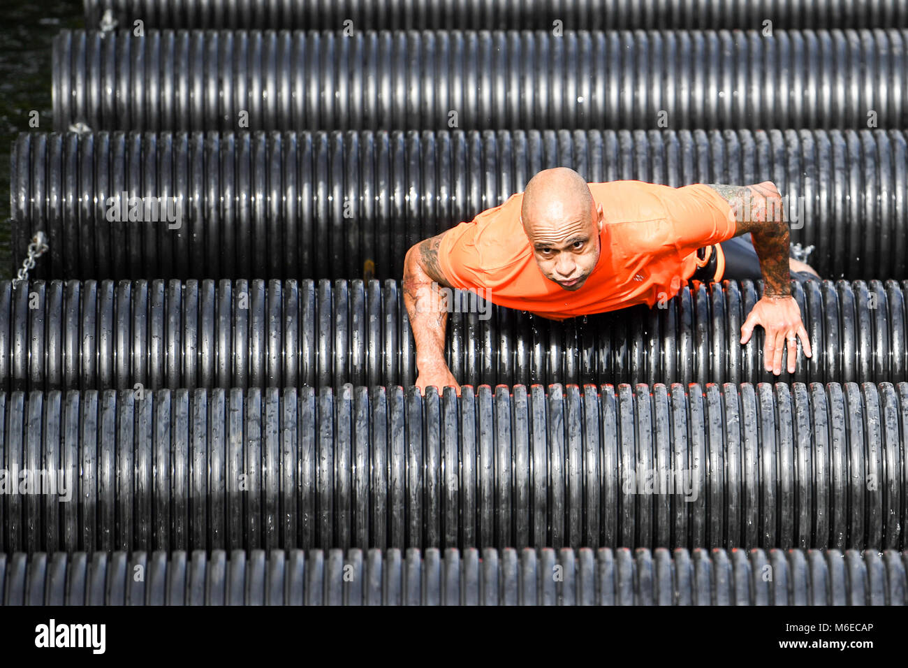 Participant crossing a water obstacle during Action run 2017 obstacle ...