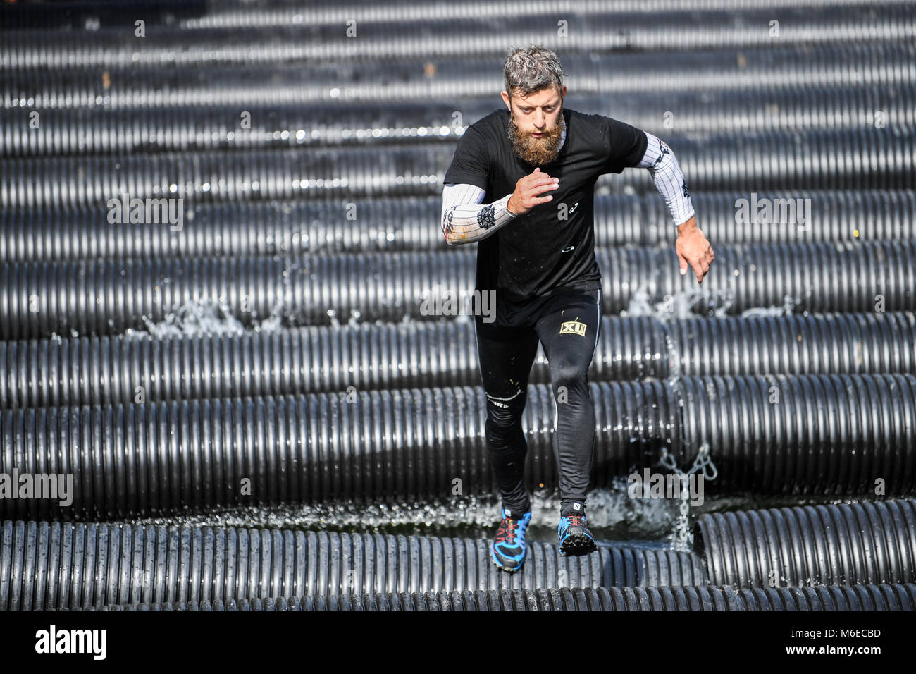 Participant crossing a water obstacle during Action run 2017 obstacle ...