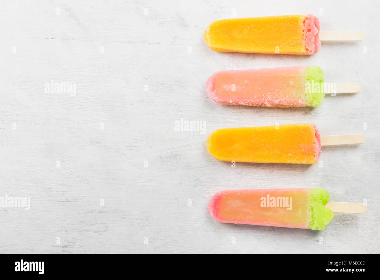 Multi-colored popsicles on a white background. Top view, copy space ...