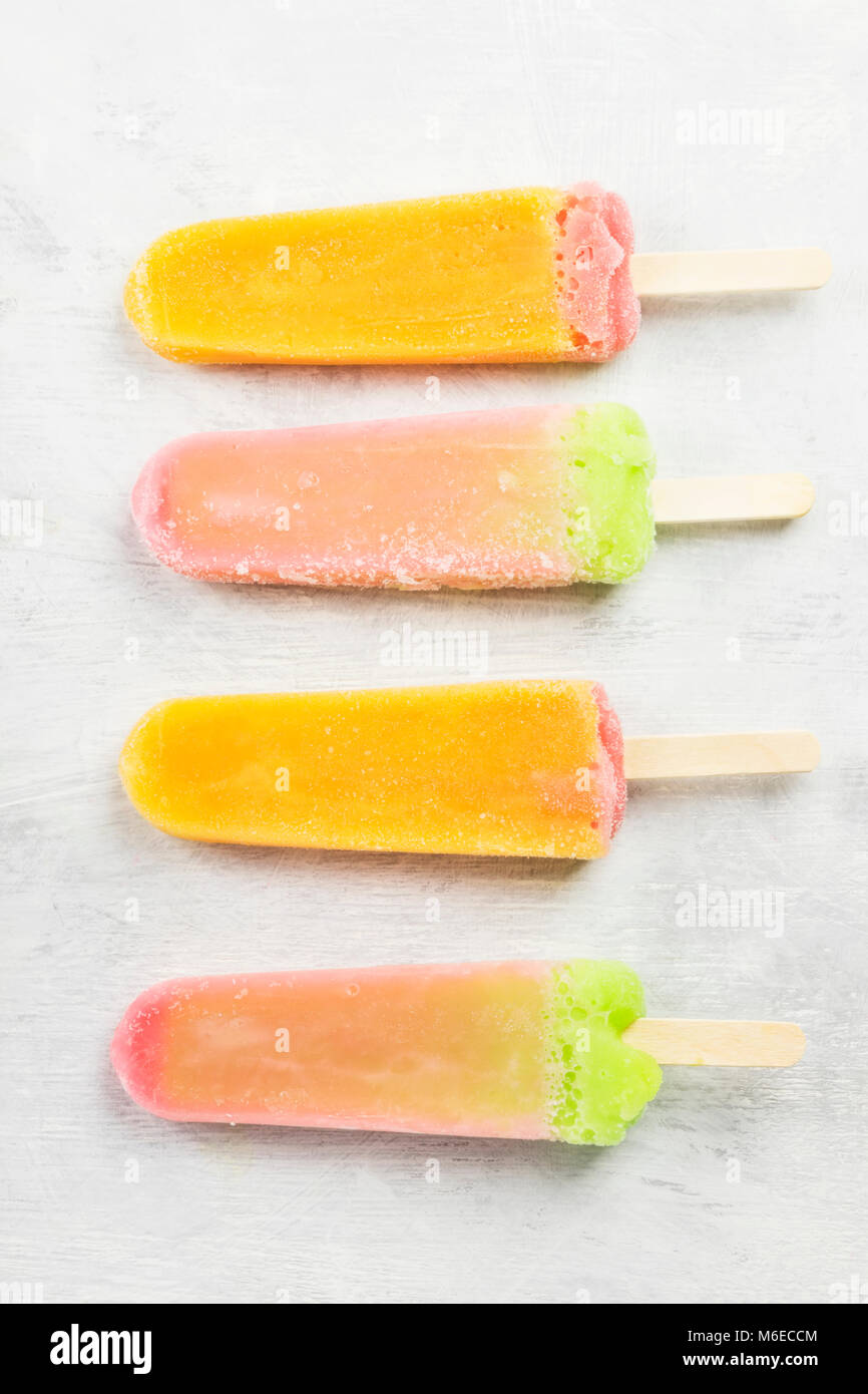 Multi-colored popsicles on a white background. Top view. Food ...