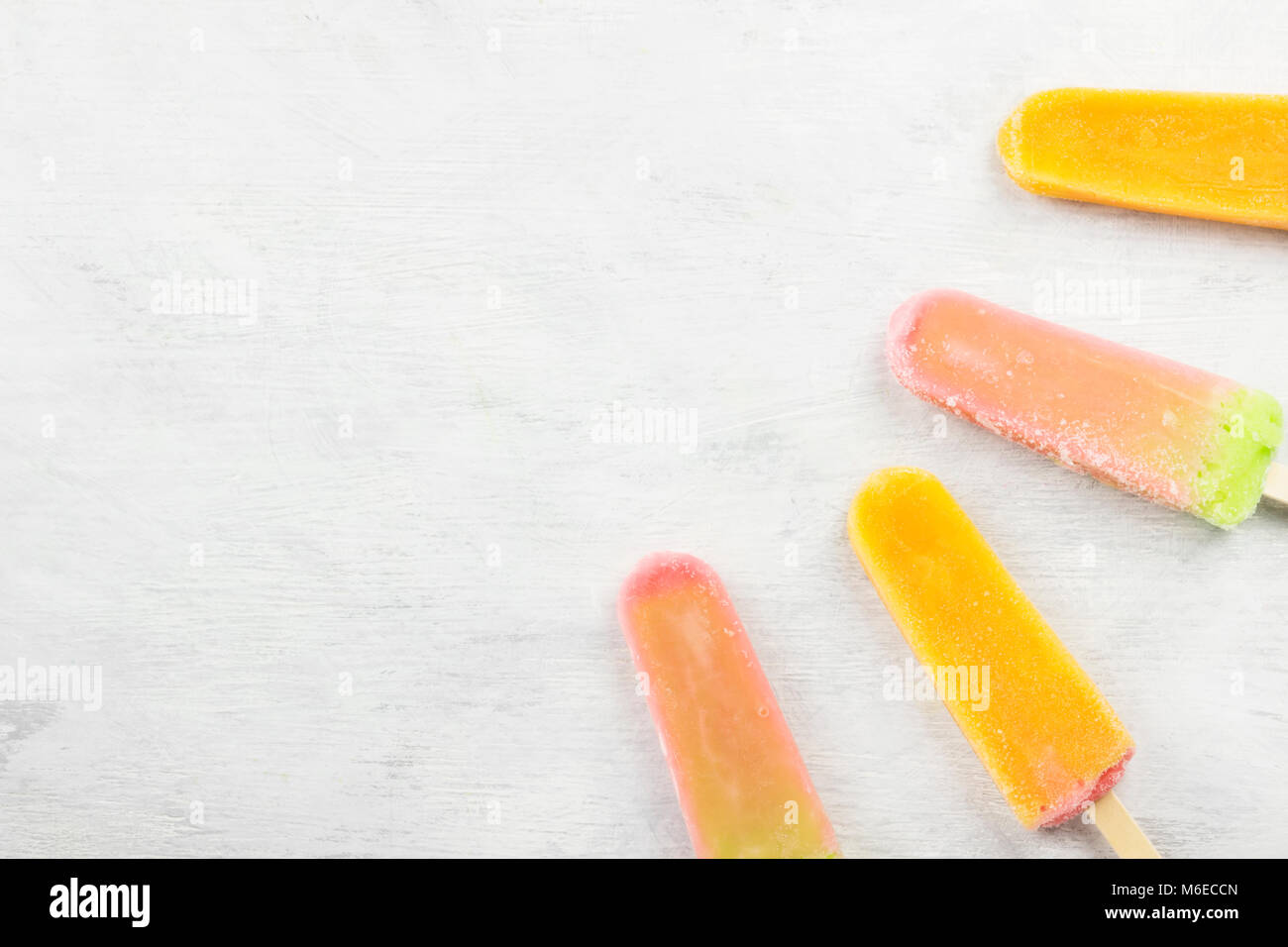 Multi-colored popsicles on a white background. Top view, copy space ...