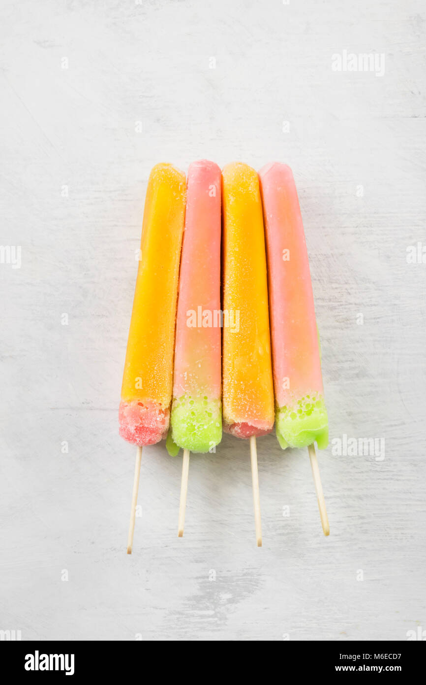 Multi-colored popsicles on a white background. Top view. Food ...