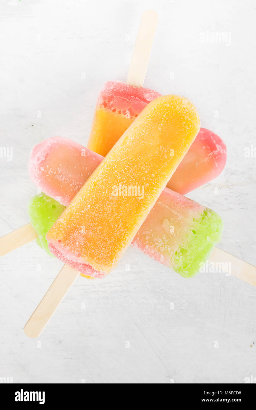 Multi-colored popsicles on a white background. Top view. Food ...